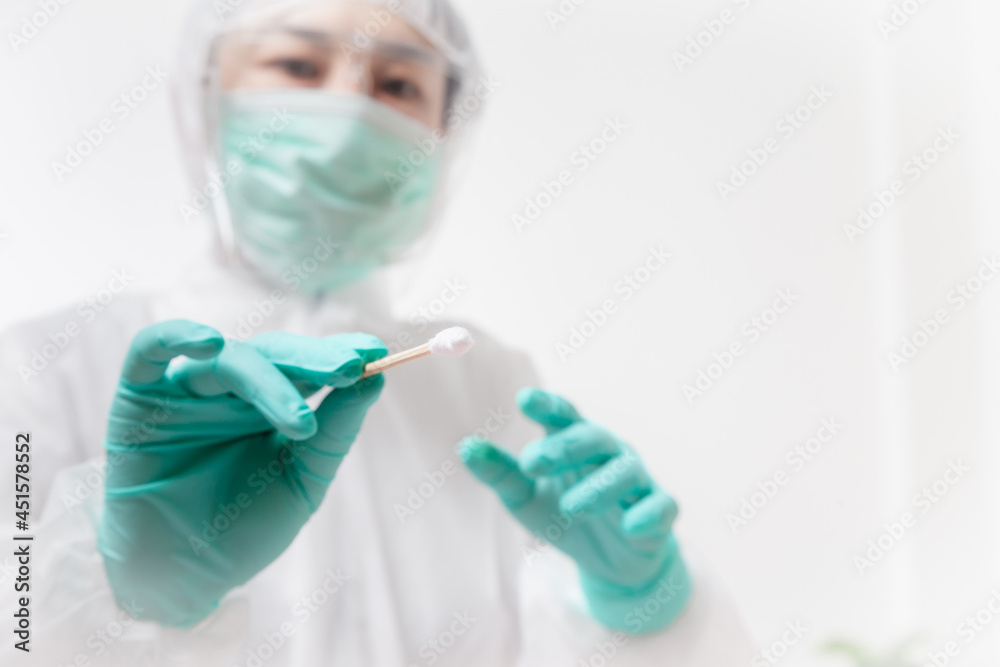 Doctor in protective suit PPE holding COVID-19 Nasal swab laboratory ...