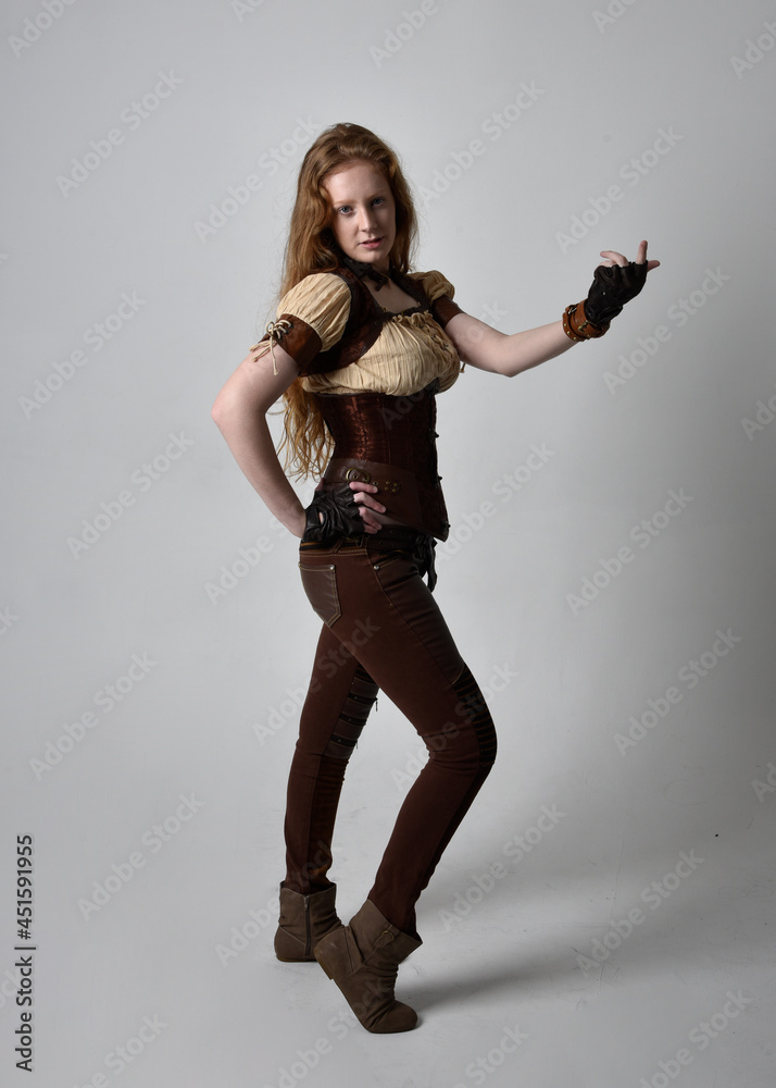Full length portrait of beautiful young woman with long red hair ...