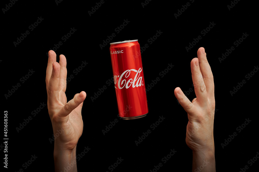 Hands catch Coca Cola can, black background Stock Photo | Adobe Stock