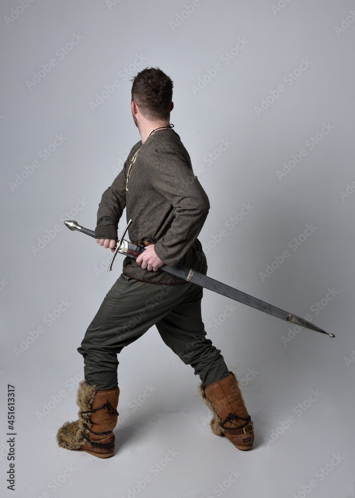 Full length portrait of young handsome man wearing medieval Celtic ...