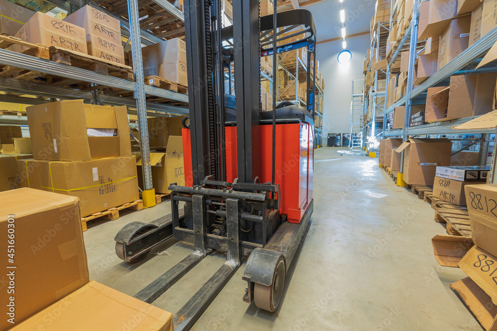 Close up view of storage warehouse. Fork lift truck in warehouse store ...
