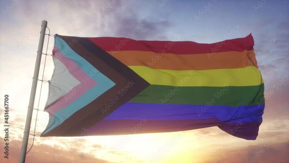 Progress LGBT flag waving in the wind, sky and sun background. LGBT ...