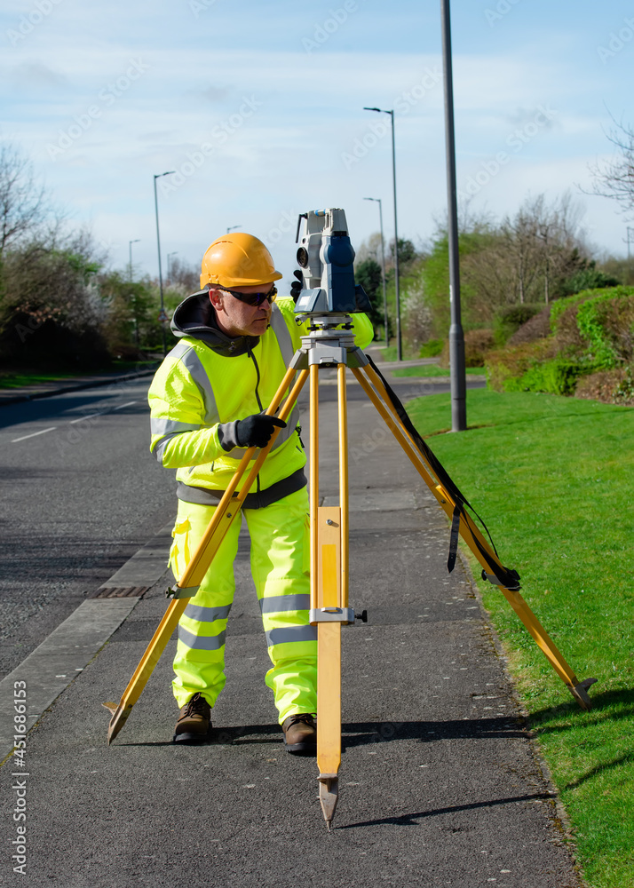 Site engineer installing tacheometer above control point before ...