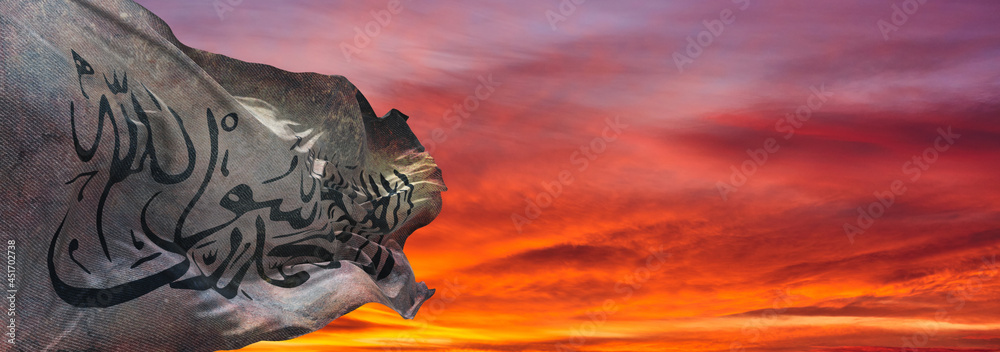 retro old white Taliban flag waving at cloudy sky background on sunset ...