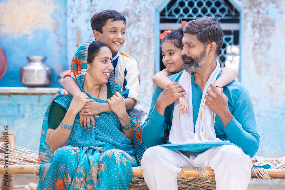 Portrait of happy rural indian family looking at each other while ...
