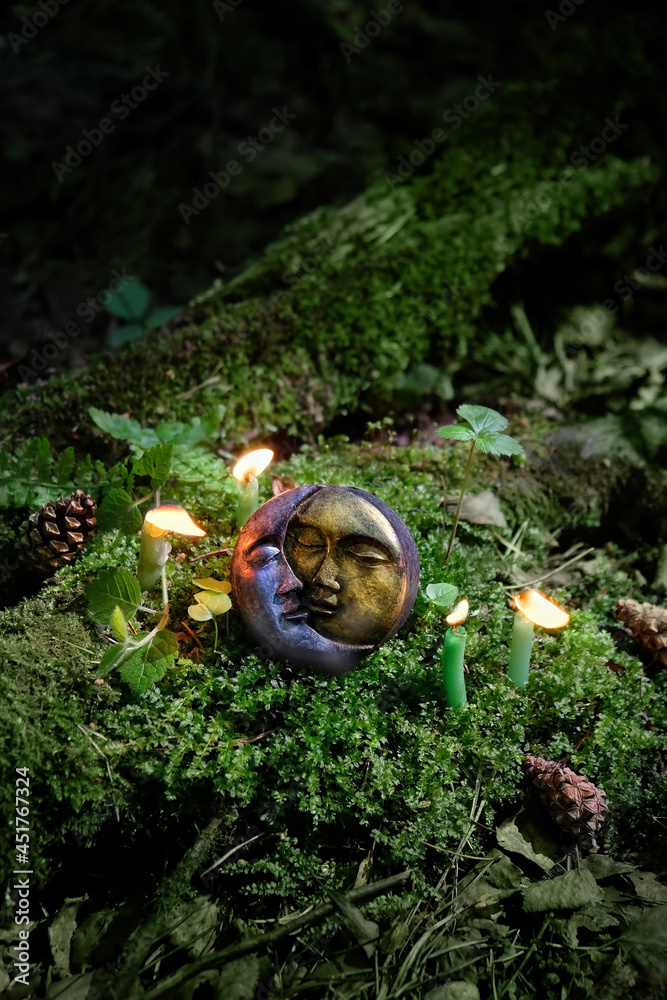 Candles and symbol of moon in mysterious forest, natural green ...