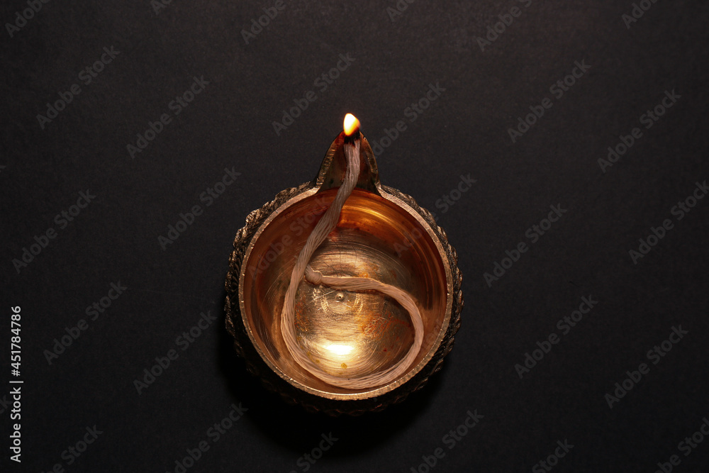 Lit diya on dark background, top view. Diwali lamp Stock Photo | Adobe ...
