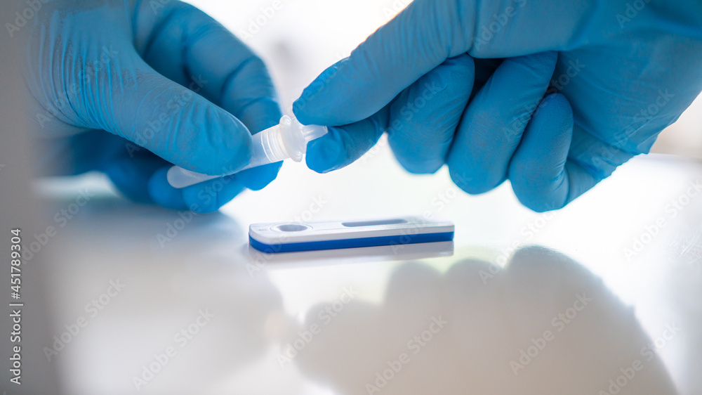 Man using a rapid antigen test kit. Rapid antigen testing is a ...