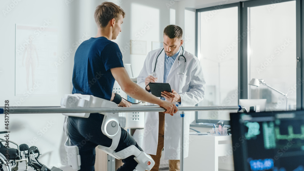 Modern Hospital Physical Therapy: Doctor Uses Tablet Computer, Helps ...