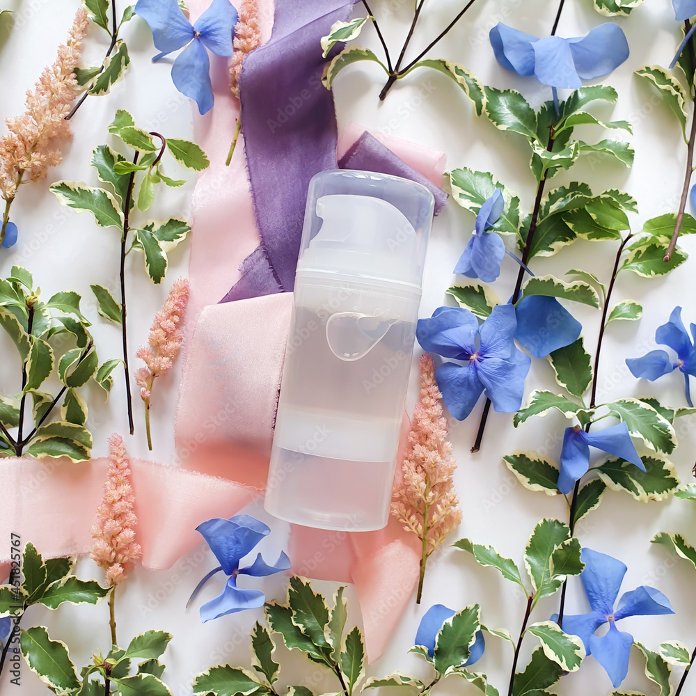 Transparent bottle of intimate lubricant gel, fresh greens, blue and ...