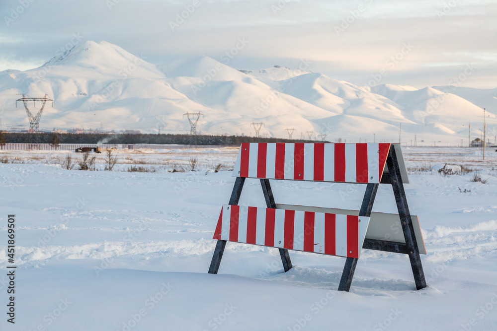 Warning sign with red lines on snow in winter Stock Photo | Adobe Stock