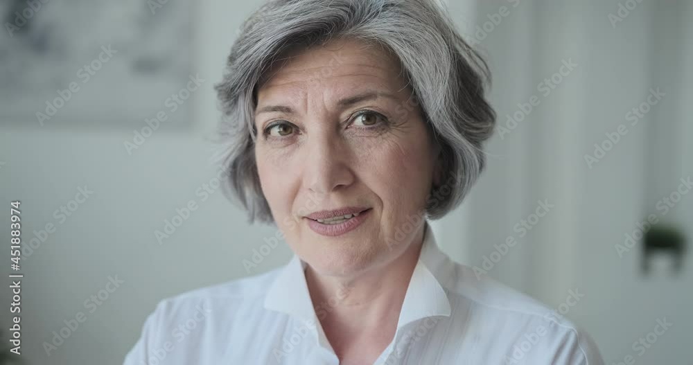Headshot smiling and gazing at the camera, a gorgeous, confident older ...