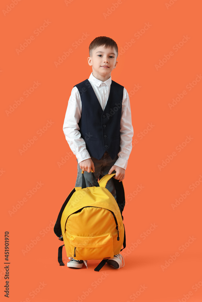 Little schoolboy with backpack on color background Stock Photo | Adobe ...