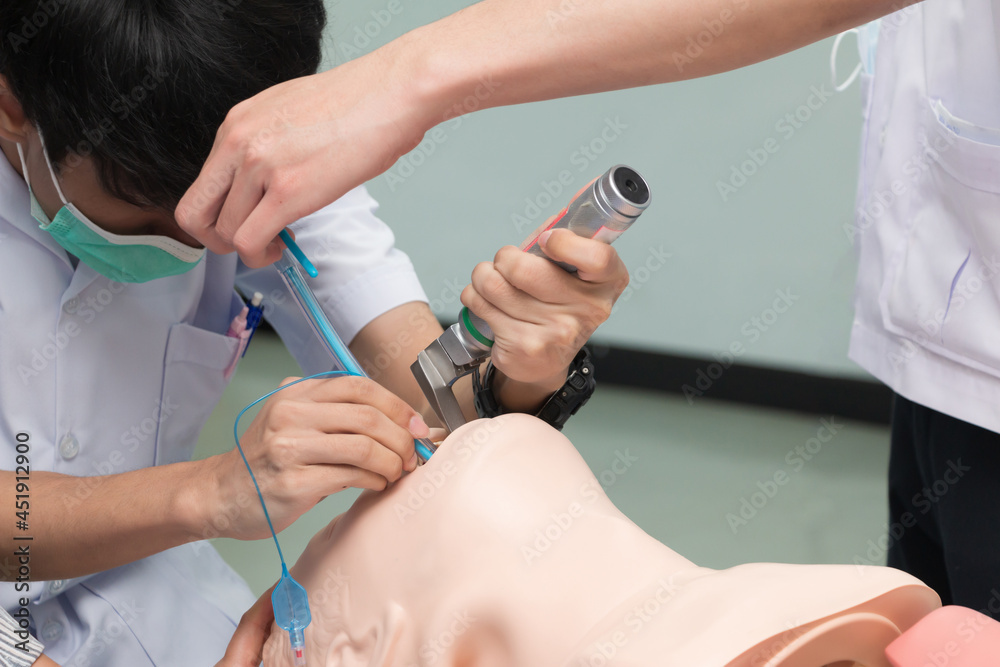 Anesthesiologist performing an orotracheal intubation on a simulation ...