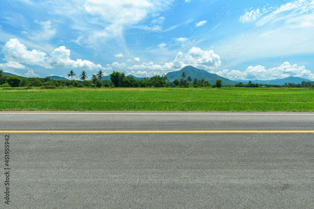 Side view of asphalt road with the meadow Stock Photo | Adobe Stock