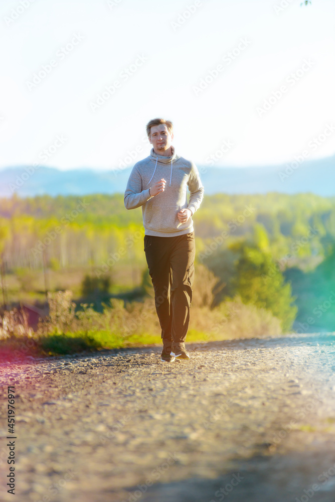 Running man jogging in rural nature at beautiful summer day. Sport ...