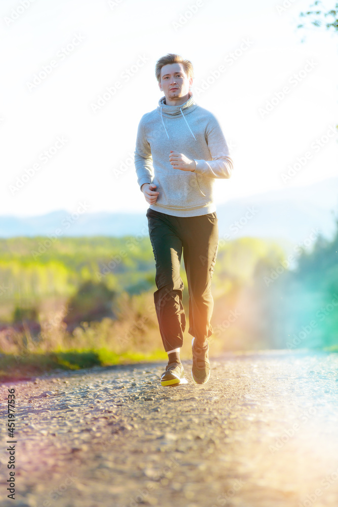 Running man jogging in rural nature at beautiful summer day. Sport ...