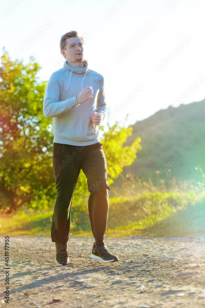 Running man jogging in rural nature at beautiful summer day. Sport ...