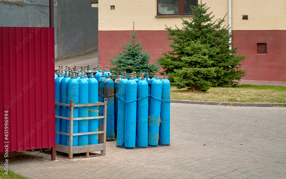 Oxygen cylinder with compressed gas standing near hospital. Blue oxygen ...