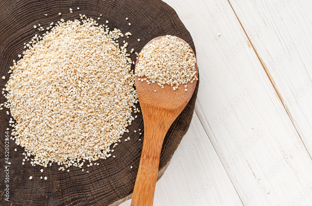 Raw dried broken barley cereal grain texture background macro closeup ...