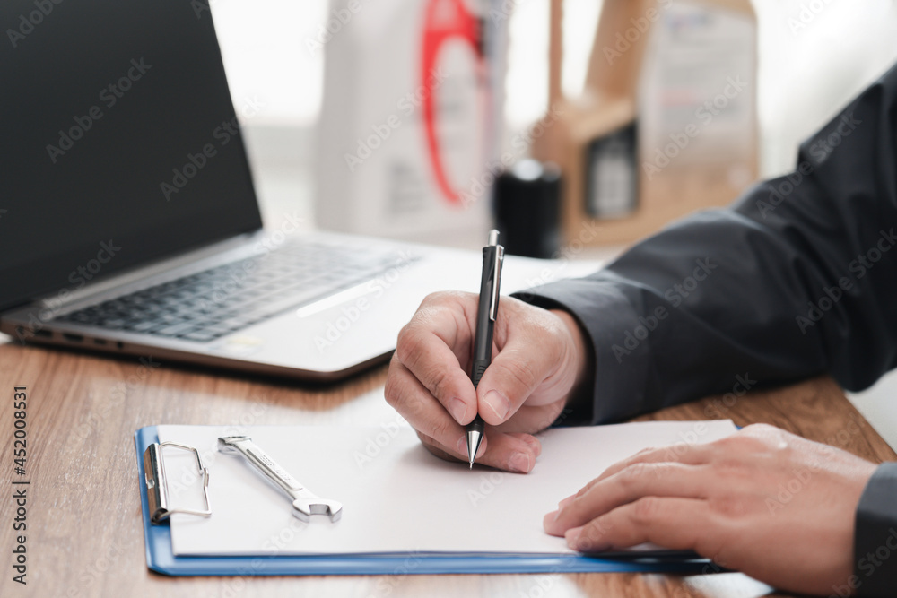 Car service staff use laptop computer check the car's mileage check ...