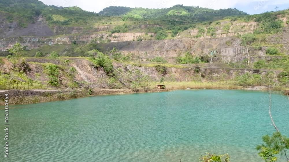 Inside the abandoned copper and gold mine pit overlooking turquoise ...