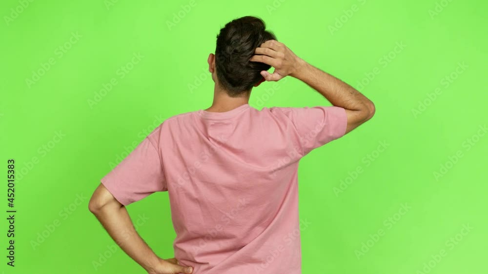 Vidéo Stock Young man on back position looking back while scratching ...