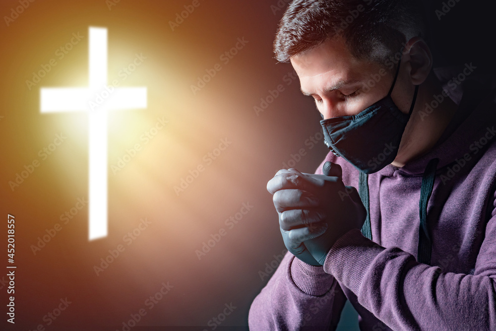 Prayer of a man in a mask and rubber gloves. A man prays for health ...