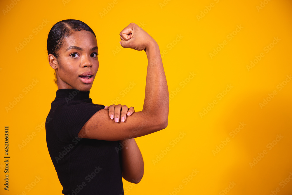 We can do it. Woman's fist of female power. Woman victim of racism ...