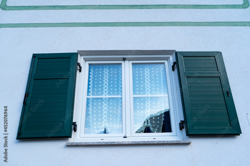 Green vintage wooden windows open is exterior window with cornice and ...
