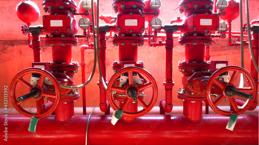 red valve in oil and gas process. Red valves on metal pipe. Valve is a ...