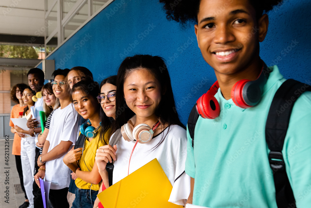 Group of multiracial teen high school students looking at camera ...