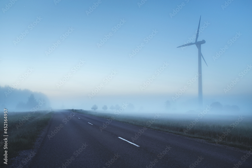Wind turbine generator and highway in a fog. Infrastructure, ecology ...