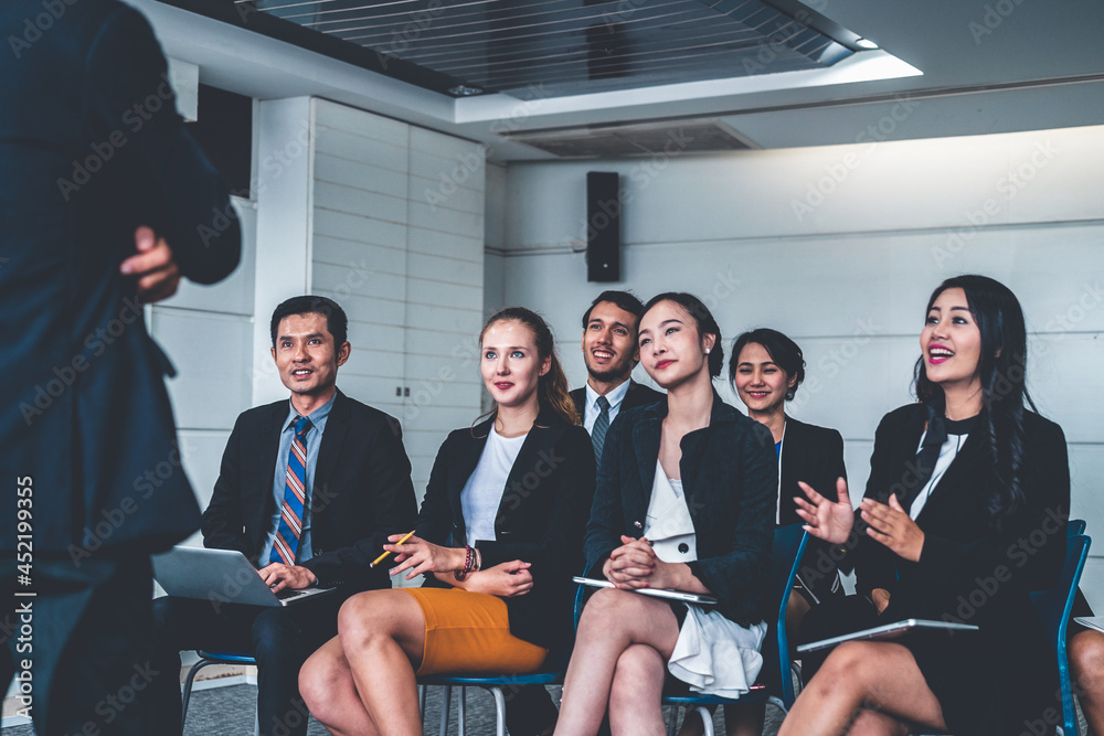 Professional young Asian and Caucasian audience applauding in group ...