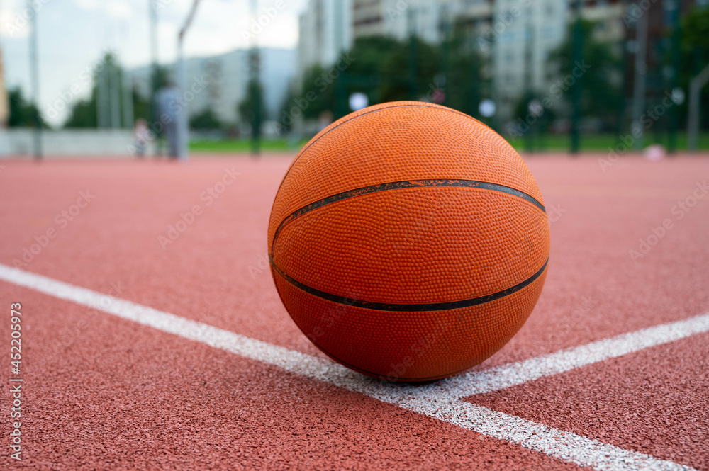 Basketball ball placed on urban street (outdoor) basketball court with ...