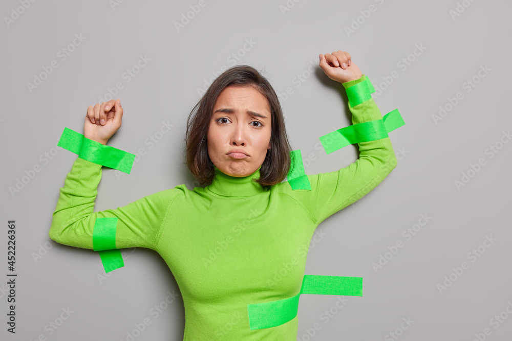 Upset Asian woman with dark hair has gloomy sulking expression ...