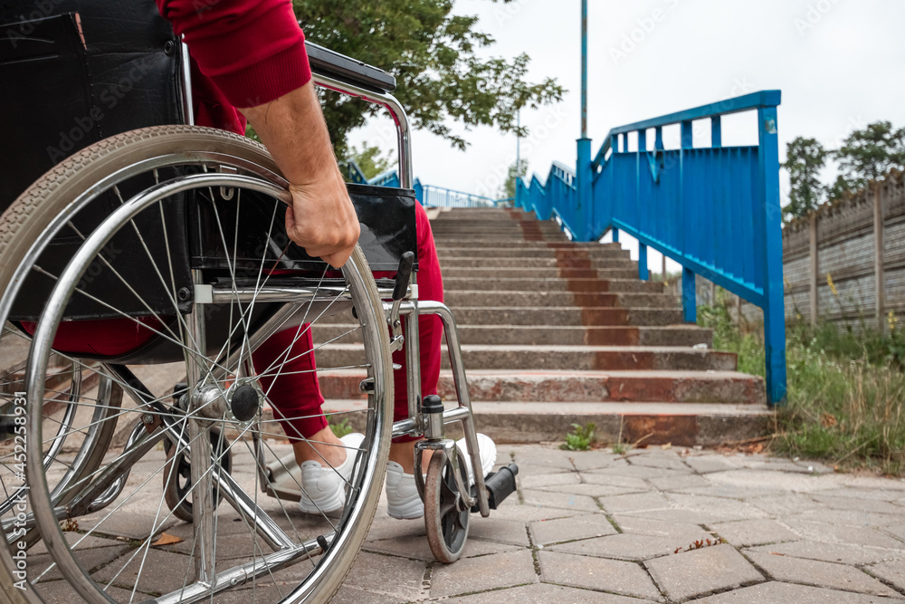 Close-up of legs in a wheelchair. The girl is disabled. The concept of ...