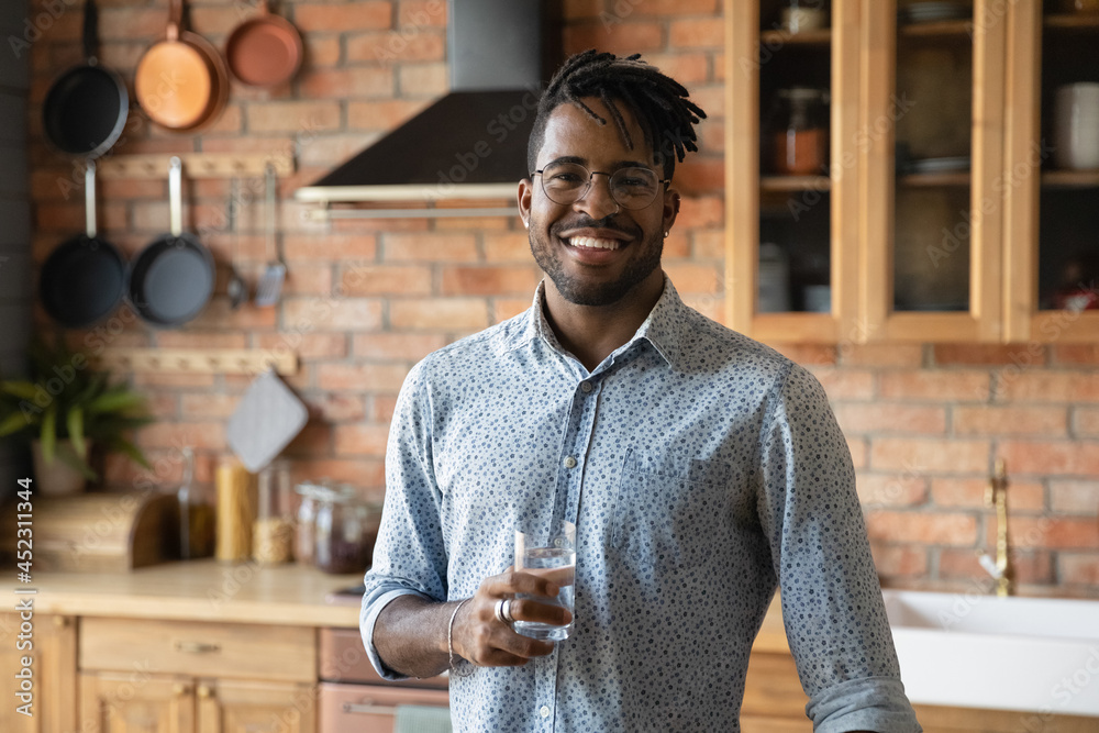 Happy handsome Black hipster guy drinking fresh pure natural water in ...