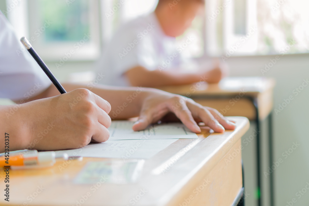Writing test in exam Asian students concentrate in high school, serious ...
