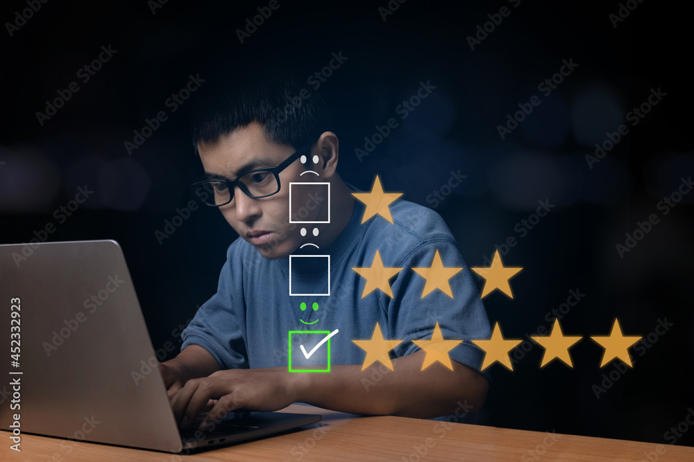 Young man browsing at his computer laptop with virtual screen on the ...