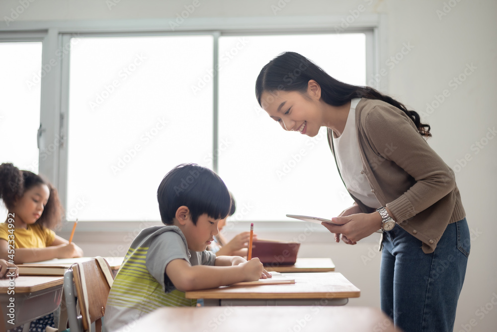 Asian Teacher teaching her diverse Multi Ethnic students at ...