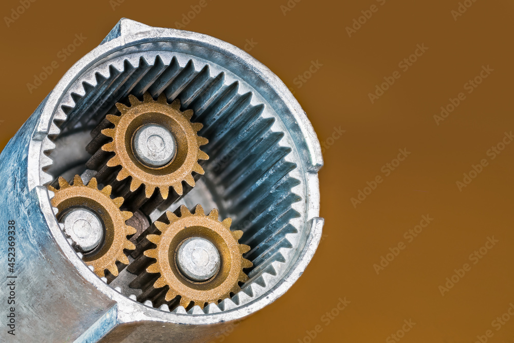 Steel cogwheels in part of planetary gearset inside screw gun on gold ...