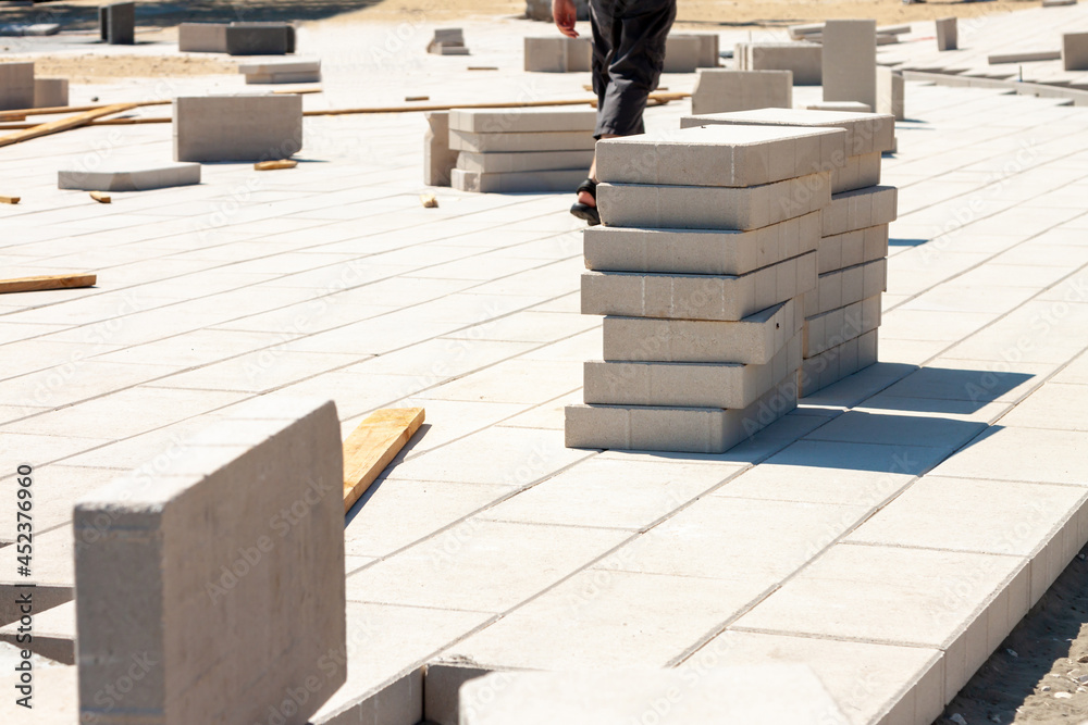 sidewalk concrete pavement bricklaying reconstruction with square stone ...