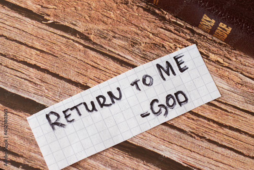 Return to God Jesus Christ. A handwritten quote on wooden background ...