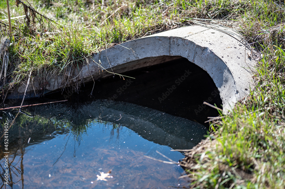 full capacity concrete culvert with sheen contaminated storm water ...