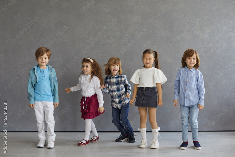 Group of happy active children in casual clothes having fun in a modern ...