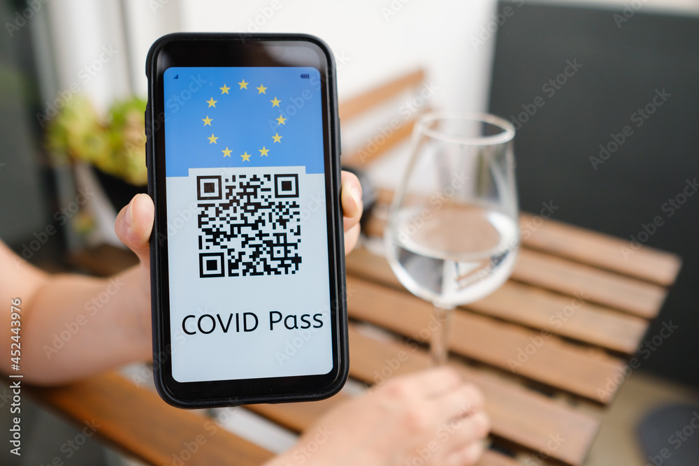 Woman demonstrates Covid pass application or digital health passport ...