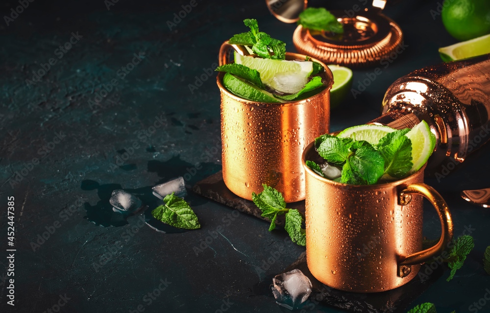 Moscow mule cocktail in copper mug with lime, ice, ginger beer, vodka ...
