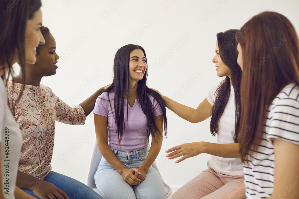 Diverse group of happy cheerful young women sitting in circle, talking ...