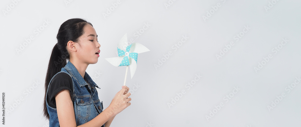 Teenage woman and paper windmill toys. Portrait teen with blue color ...